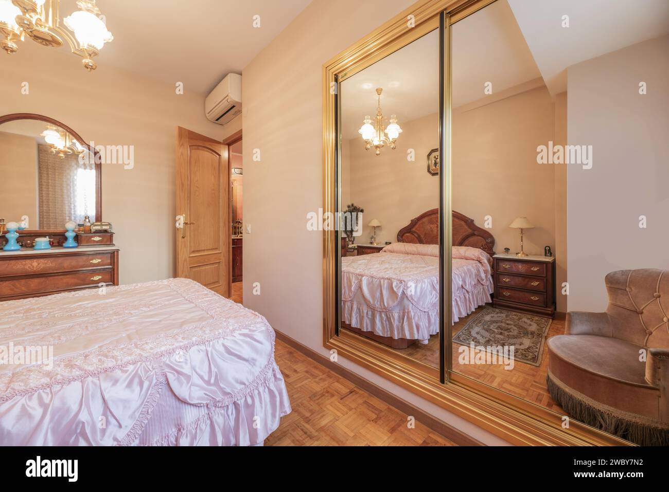 Double Bedroom With Wooden Furniture Pink Bedspread And A Built In