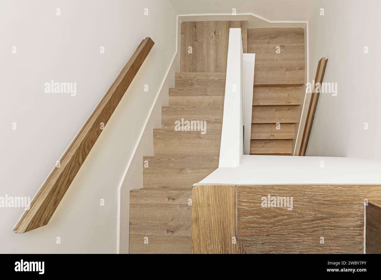 Stairs with oak wood steps with handrails of the same material and ...