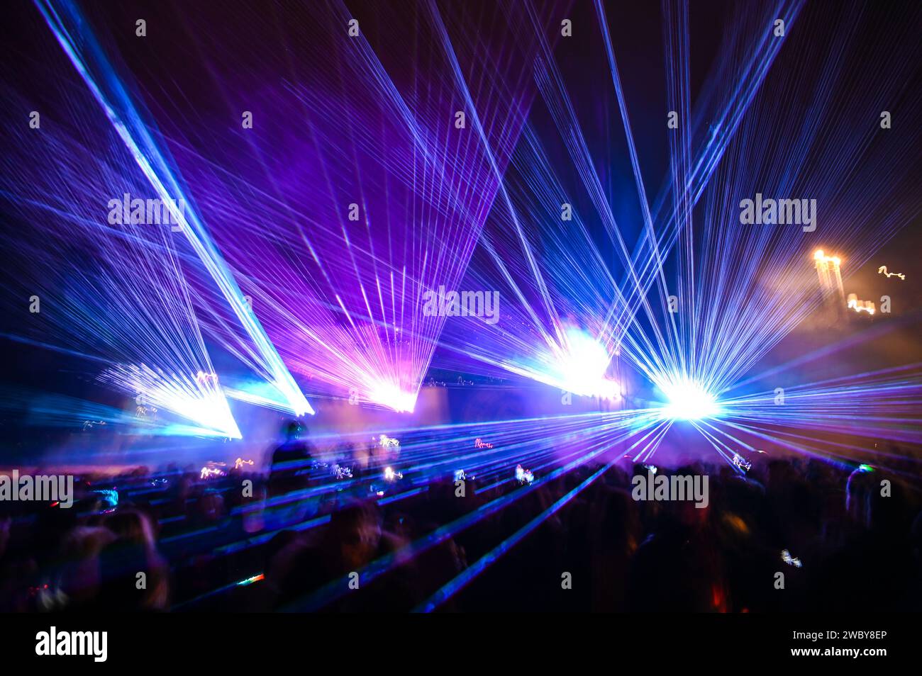 Multicolored light show at night. Laser lights and fog on the stage ...