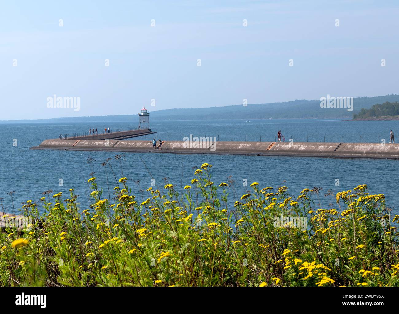 TWO HARBORS, MN – 7 SEP 2023: People walking on the concrete breakwater ...