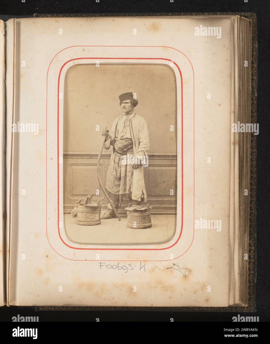Portrait of a man in Romanian traditional costume with yoke and wooden ...