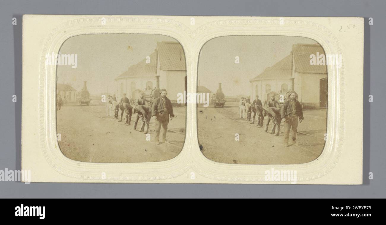Seven men on a train track, in the distance a steam locomotive ...