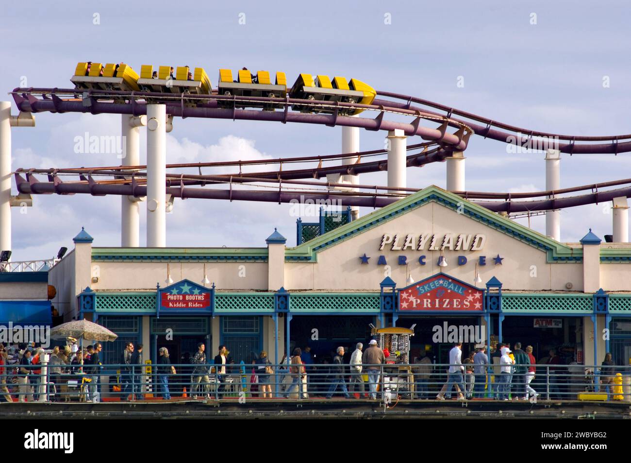 Santa Monica Pier arcade with roller coaster behind in Santa Monica ...