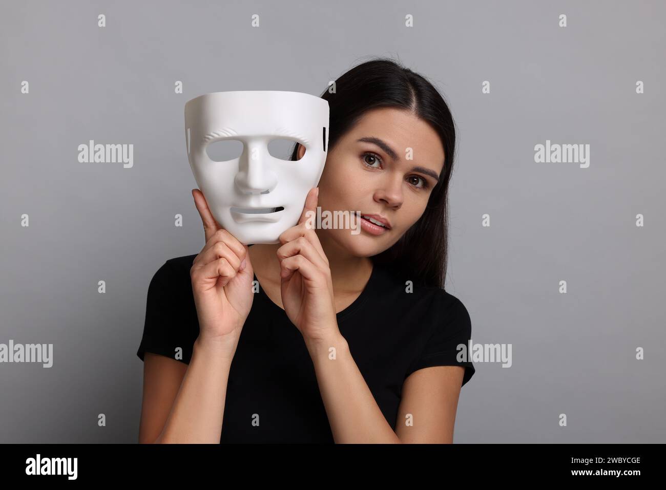 Multiple personality concept. Woman with mask on grey background Stock ... Multiple personality concept. Woman with mask on grey background Stock ...