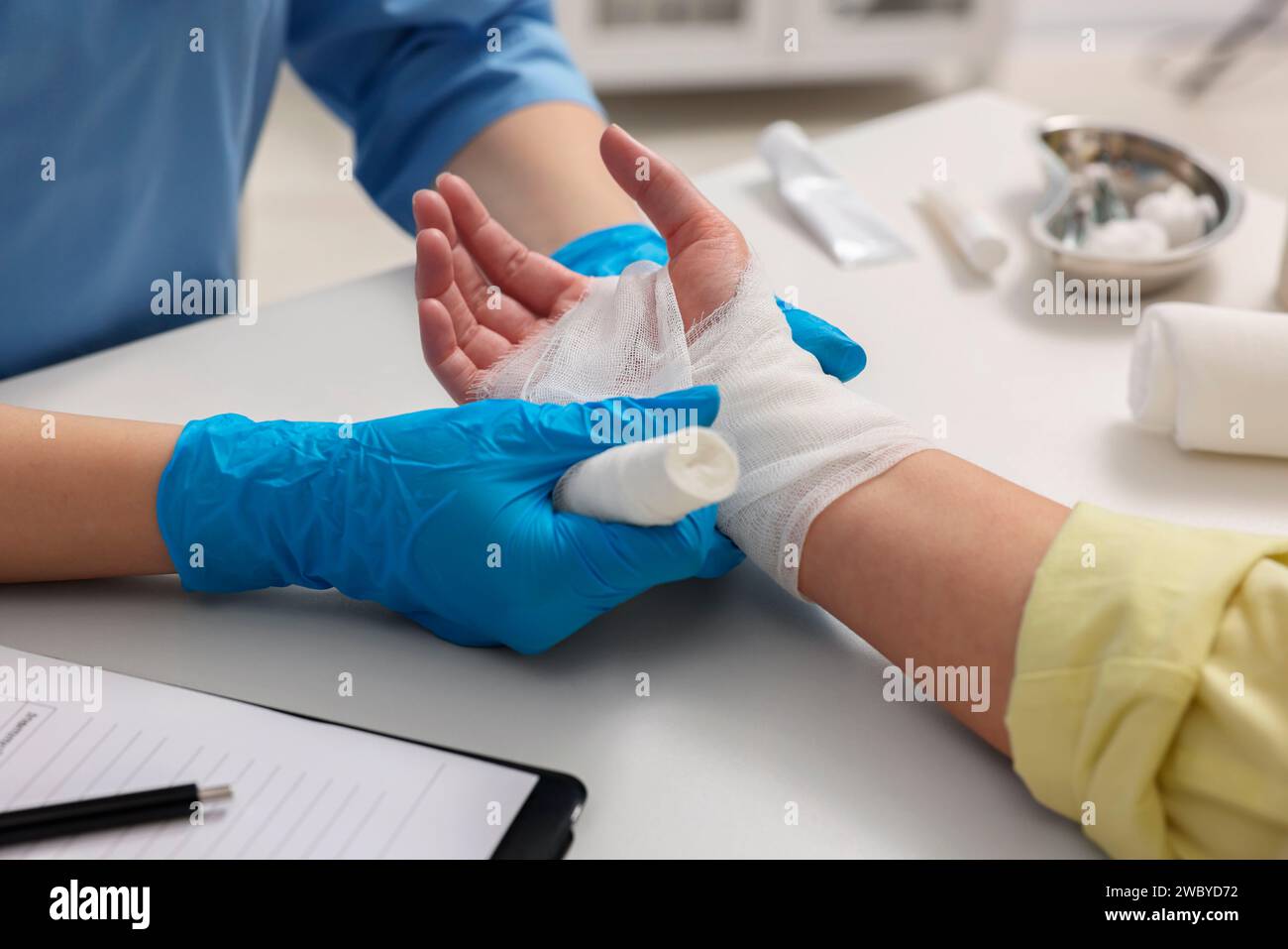 Doctor bandaging patient's burned hand in hospital, closeup Stock Photo ...