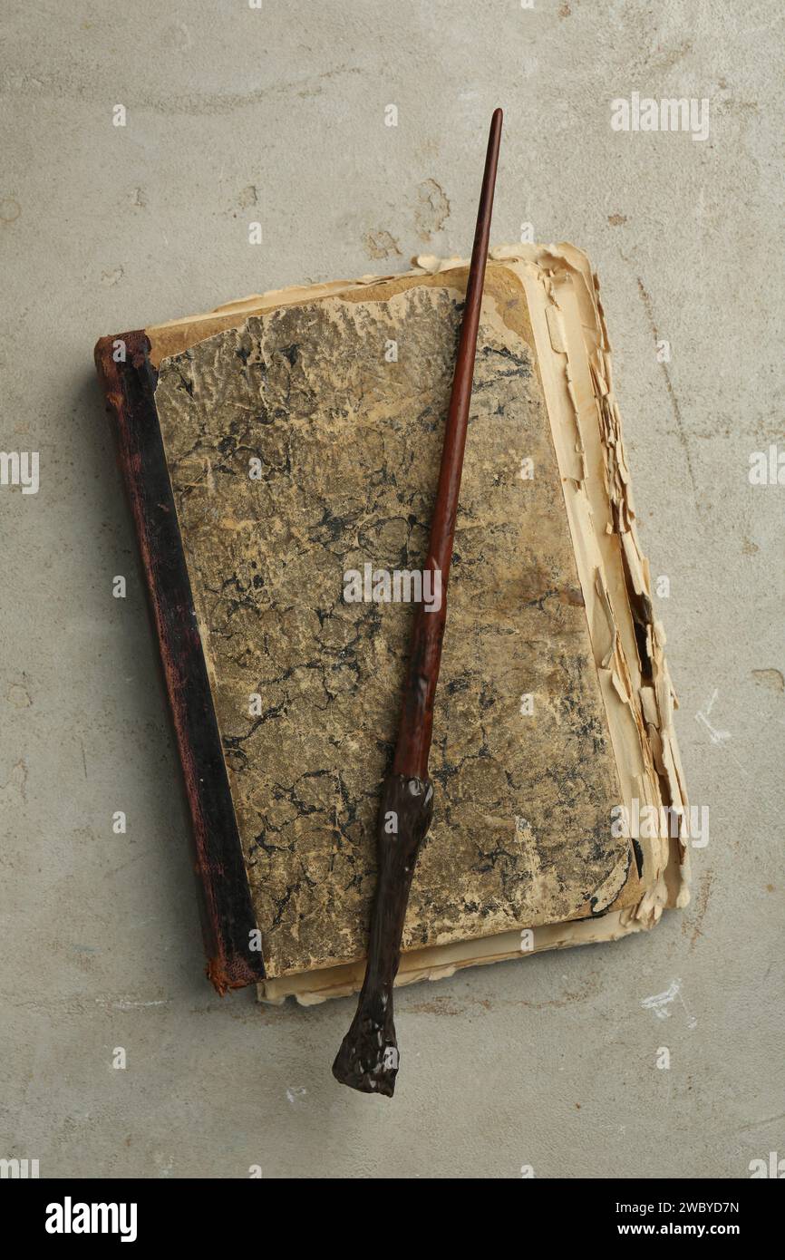 Magic wand and old book on light textured background, top view Stock ...