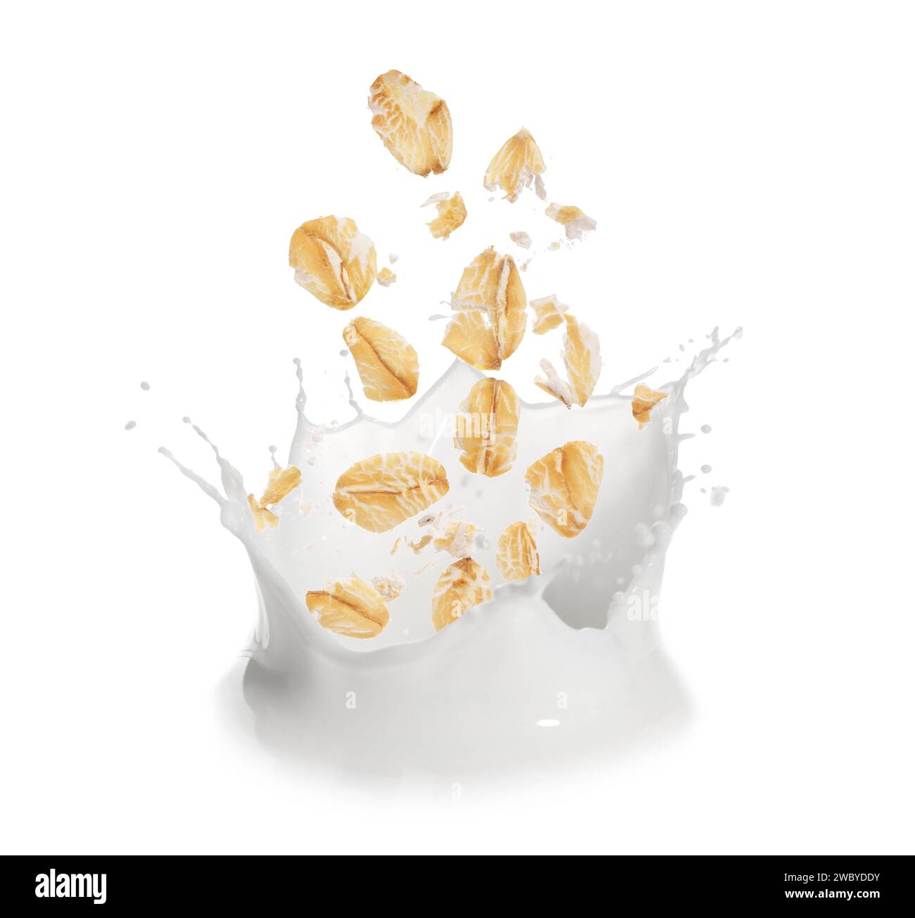 Rolled oats falling into splashing milk on white background Stock Photo ...