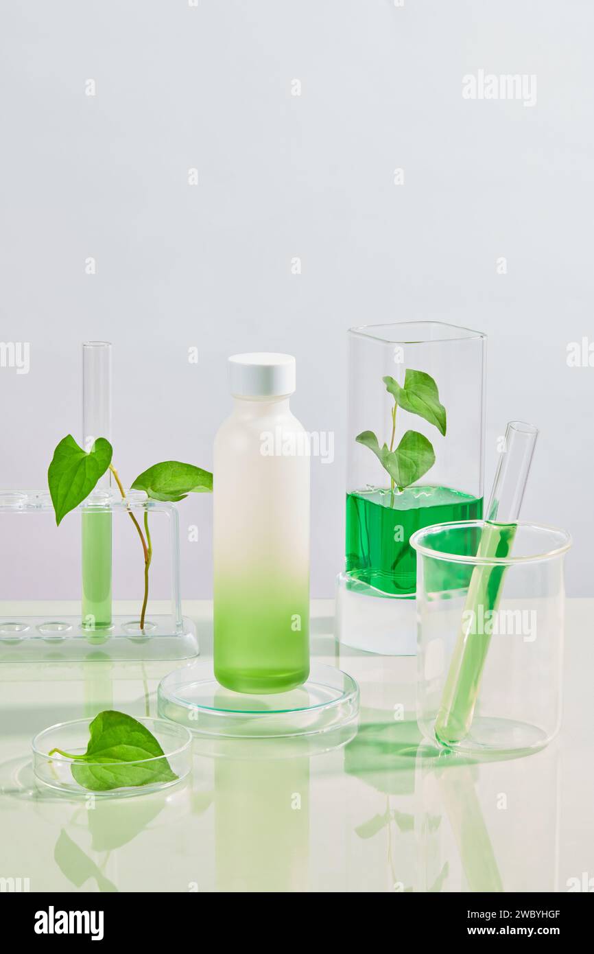 Scientific glassware filled with green liquid displayed around a ...