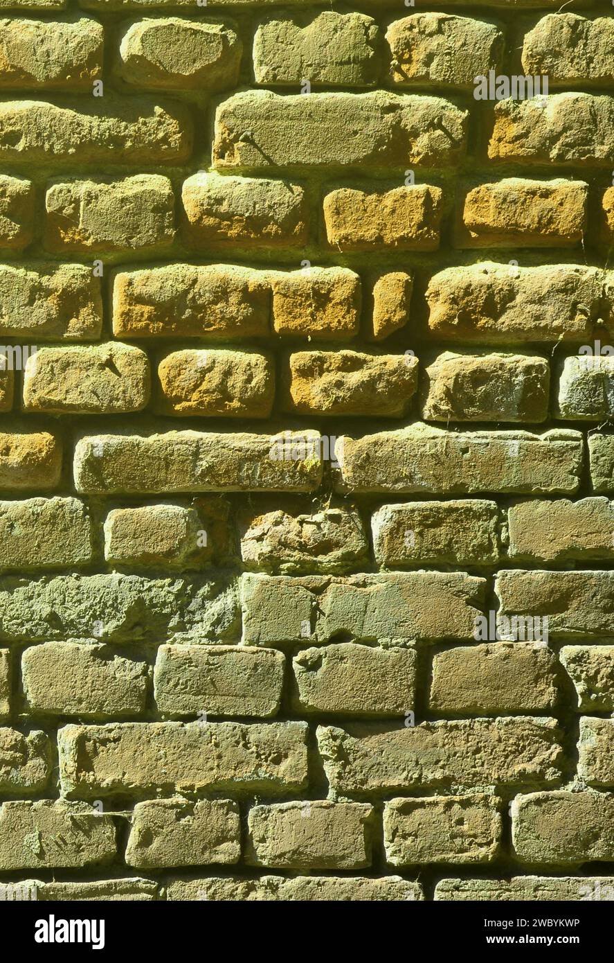 Vertical wall texture of several rows of very old brickwork made of red ...