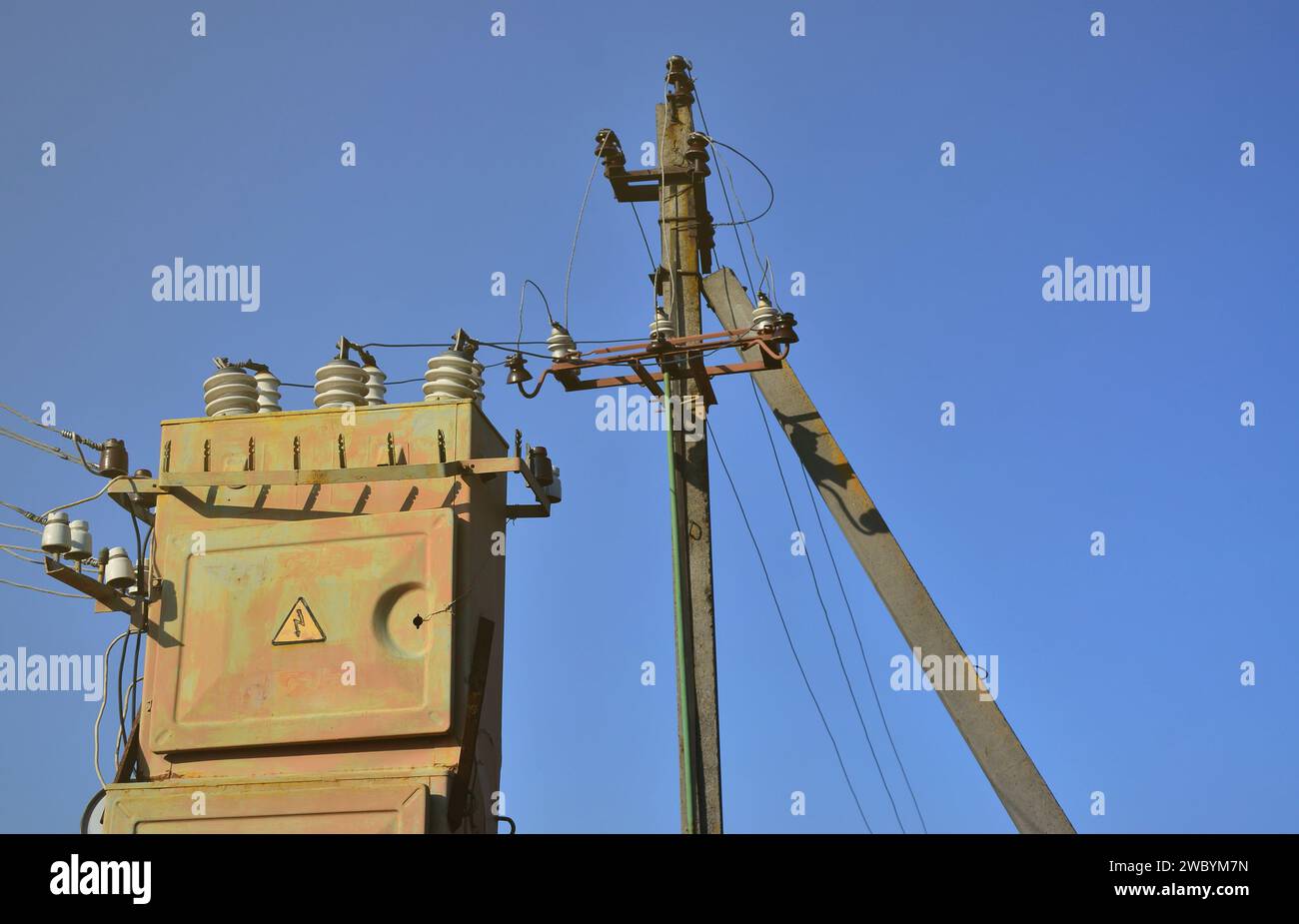 Old and obsolete electrical transformer against the background of a ...