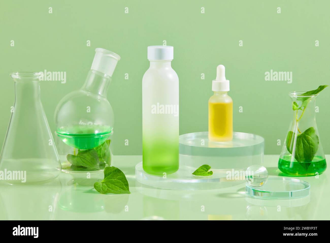 Cosmetic containers standing on round podiums with some glassware and ...