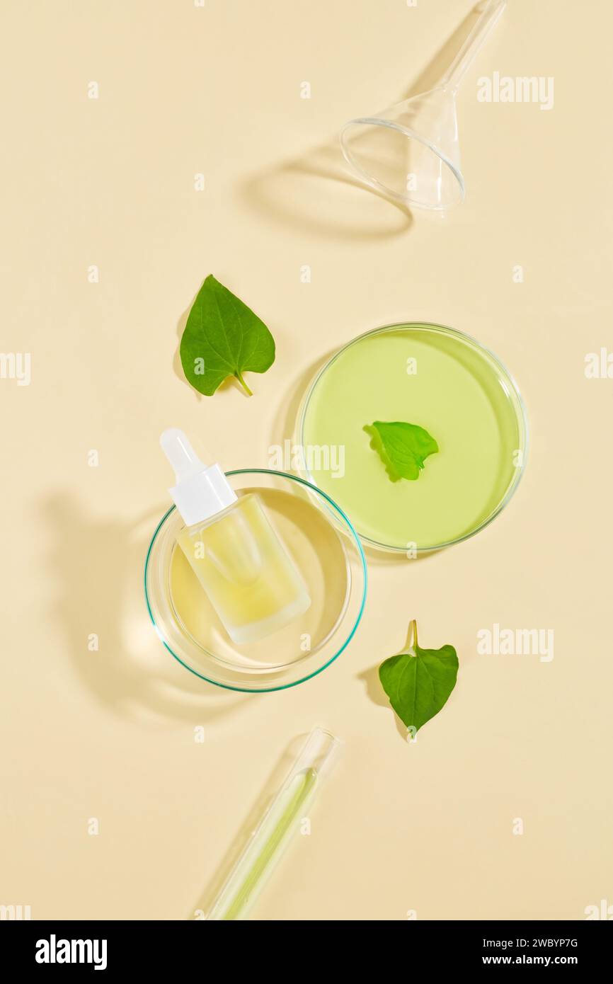 Two petri dishes containing unbranded dropper bottle and green liquid ...