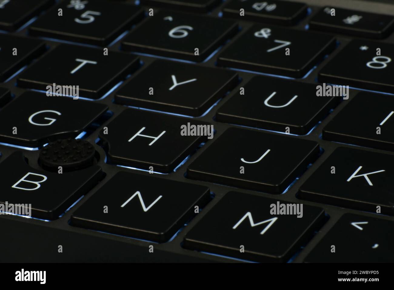 Low angle close up of laptop keyboard illumination, backlit keyboard ...