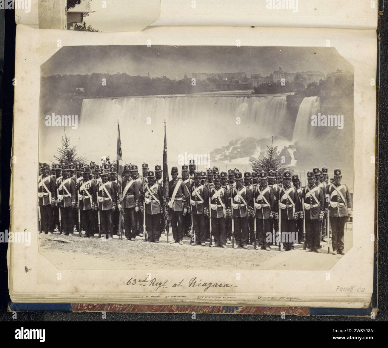 Group portrait of a regiment of soldiers against a painted decor of the ...