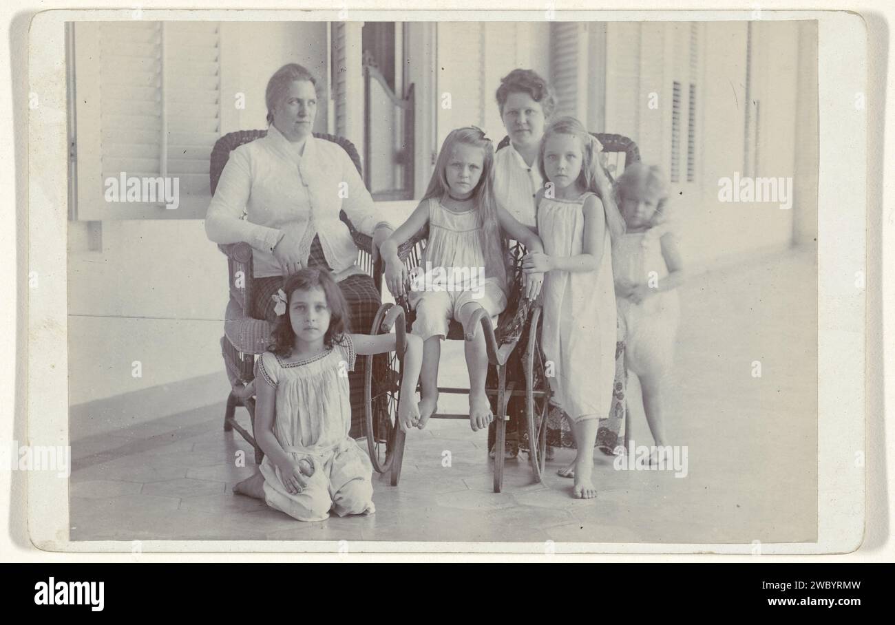Group portrait of two unknown women and four unknown girls on a porch ...