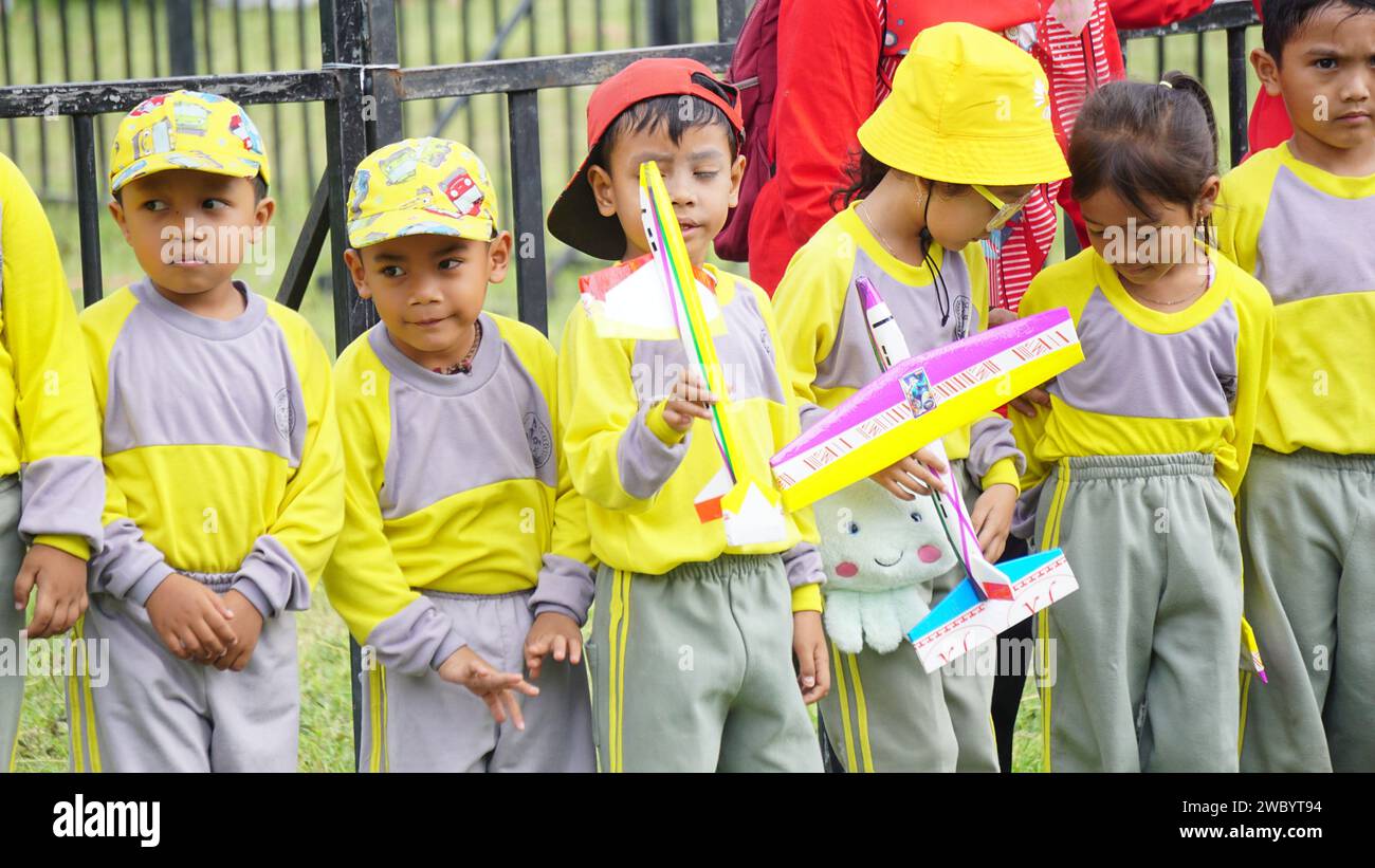 Kindergarten student play toy plane with friends Stock Photo - Alamy