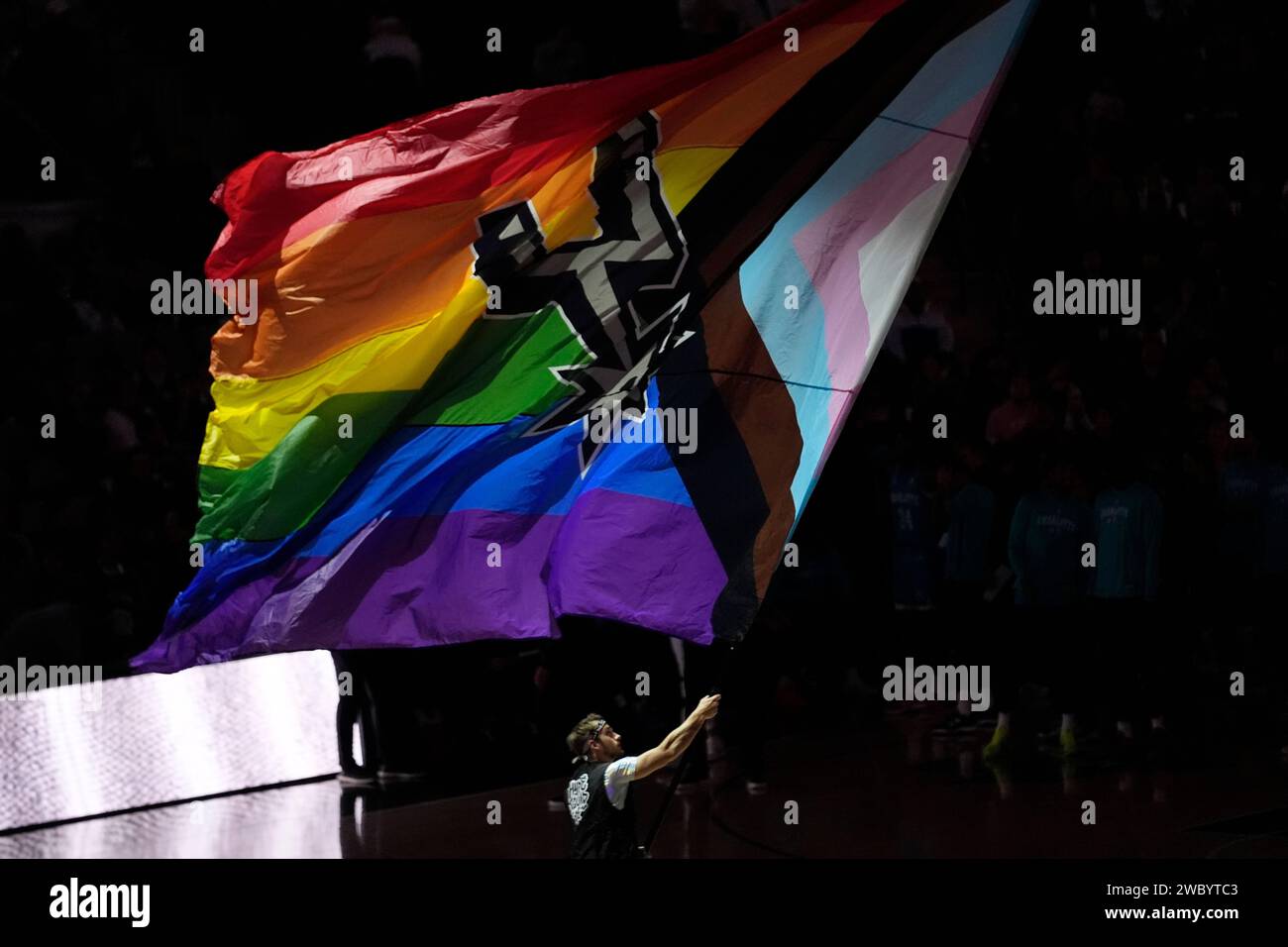 A San Antonio Spurs themed pride flag is waves during an NBA basketball ...