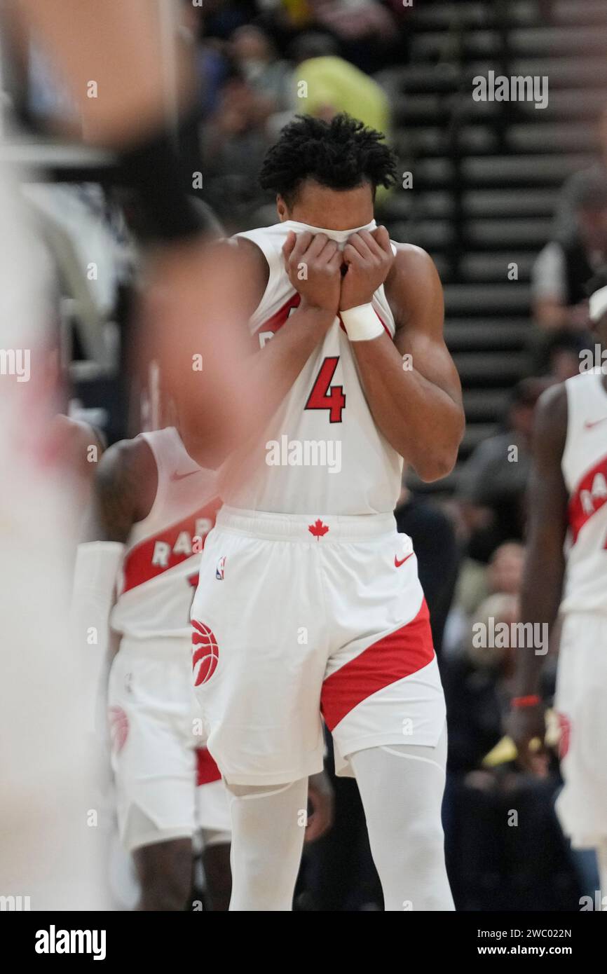 Toronto Raptors forward Scottie Barnes covers his face as he heads to ...