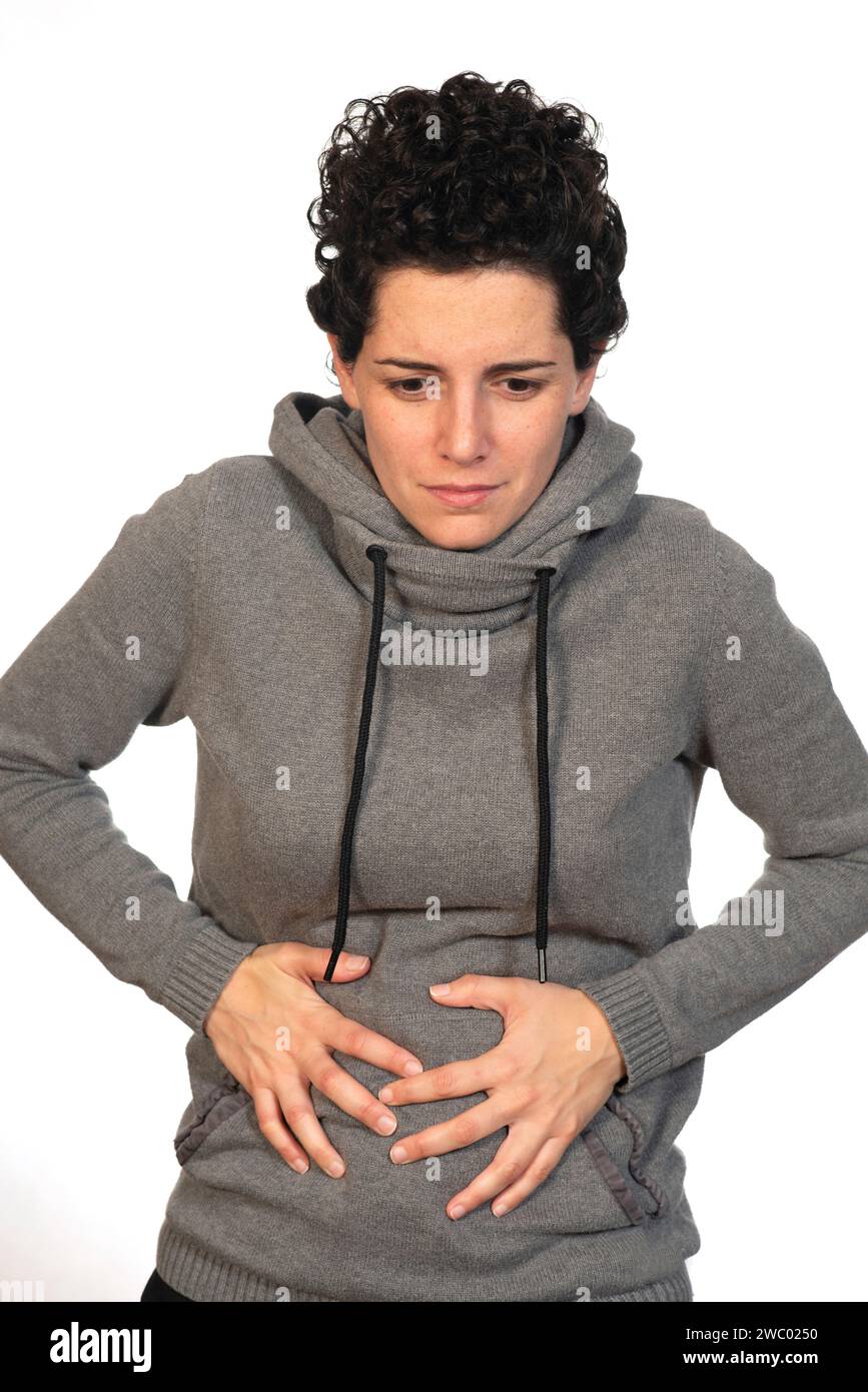Woman with belly pain against white background Stock Photo - Alamy