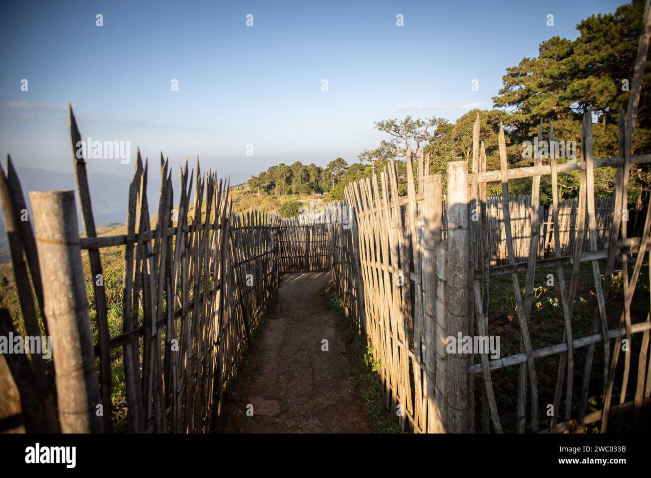 Narrow pathway surrounded by high bamboo fences to enter the Chang Moob ...