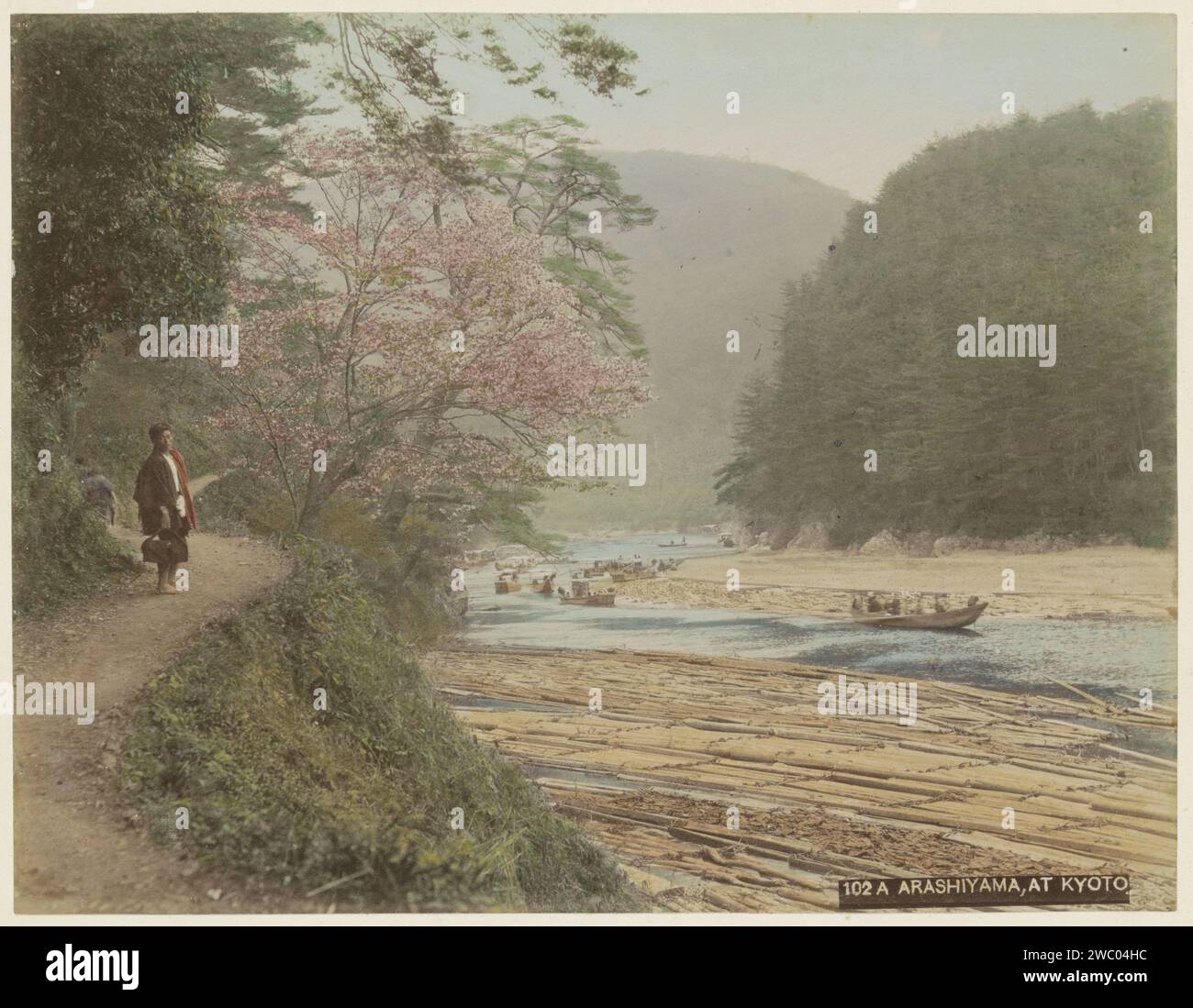 View of a river with floating tree trunks and boats in Arashiyama ...