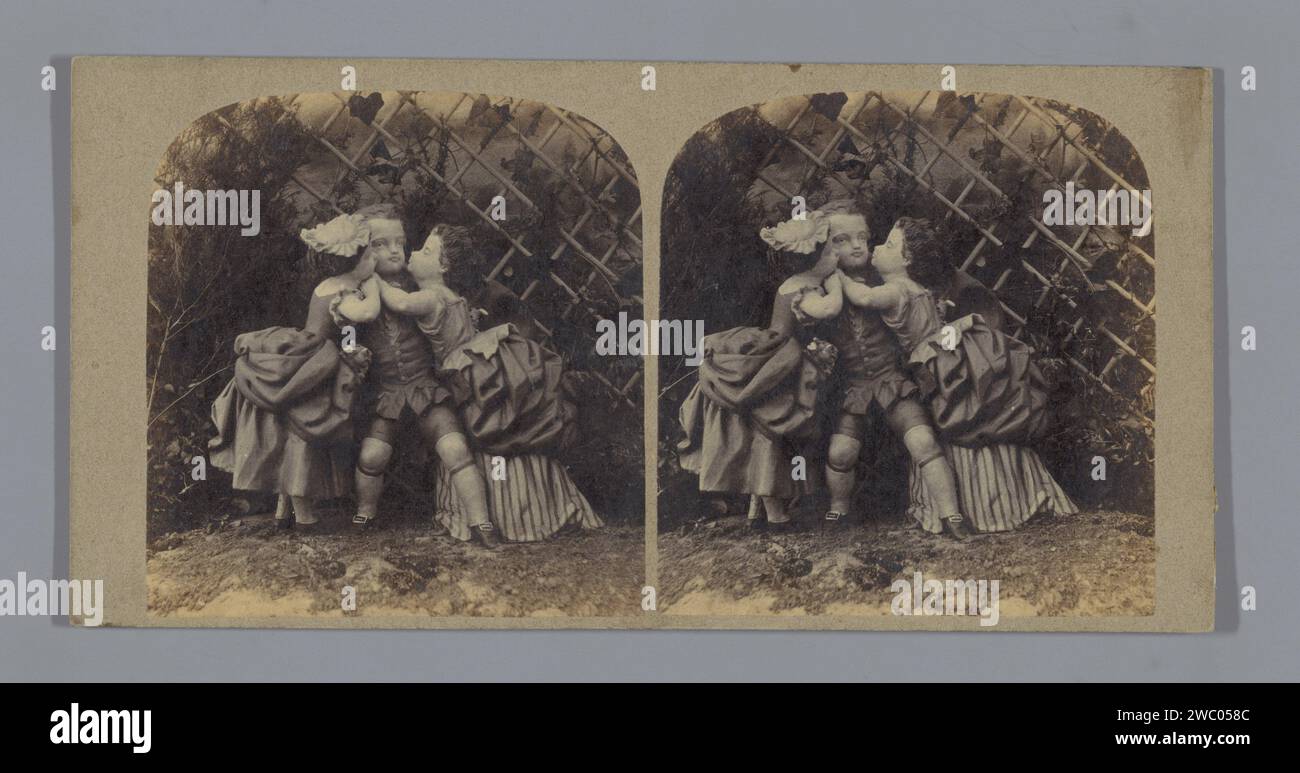 Staging with three dolls, representing a boy who is kissed by two girls ...