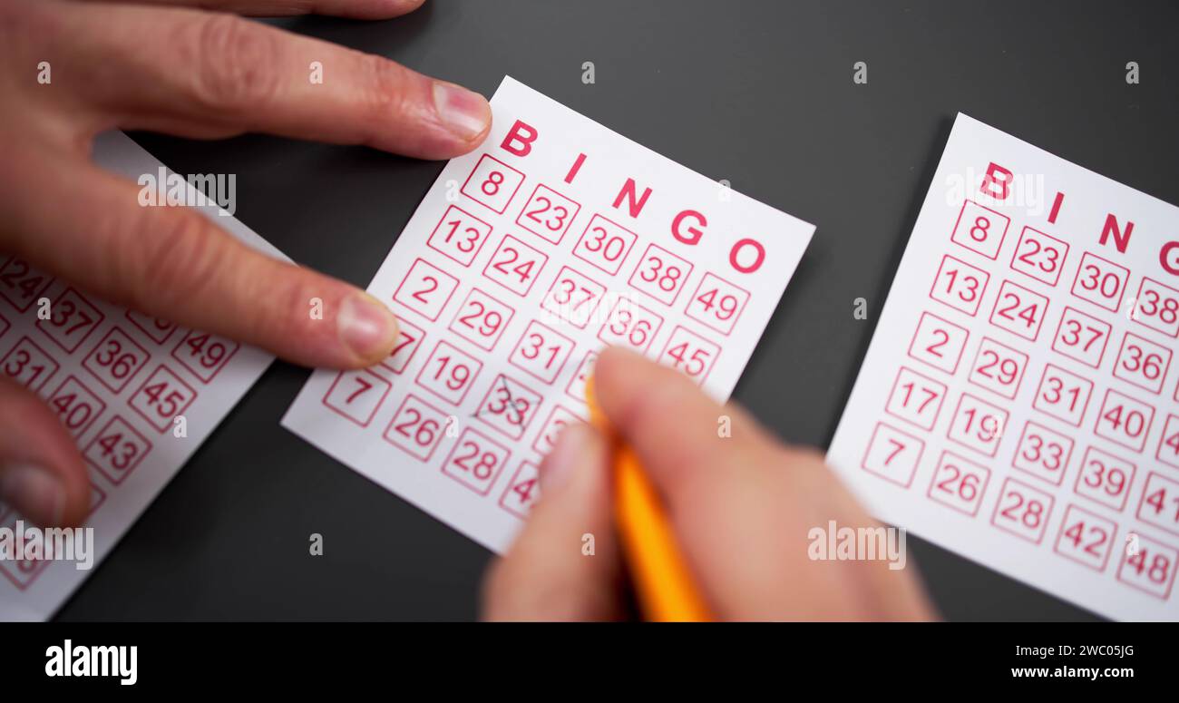 Person's Hand Marking Number On Lottery Ticket With Pen Stock Photo - Alamy