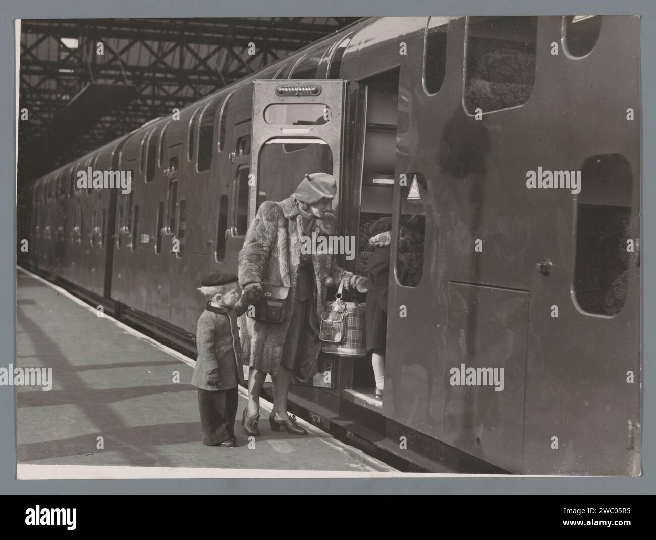 Woman and two children board a double -deck train on Charing Cross ...