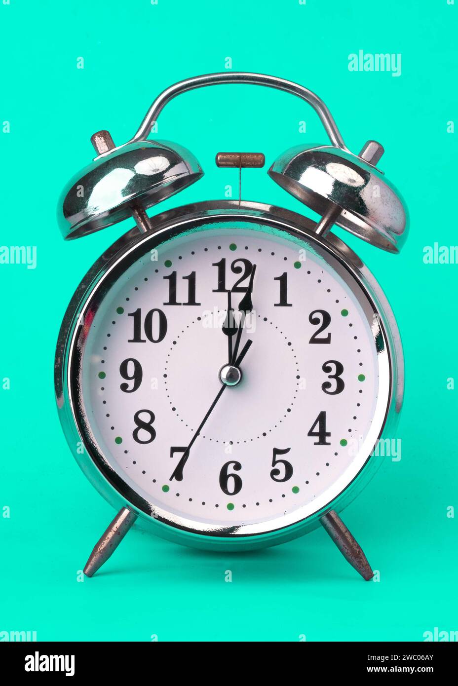 Classic vintage alarm clock isolated on green background. Retro alarm ...