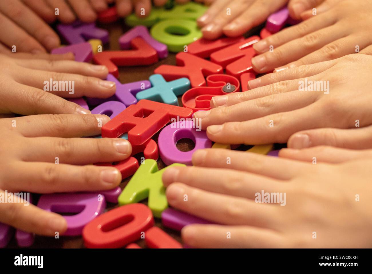 kids put hands on english colorful letters, close up Stock Photo - Alamy
