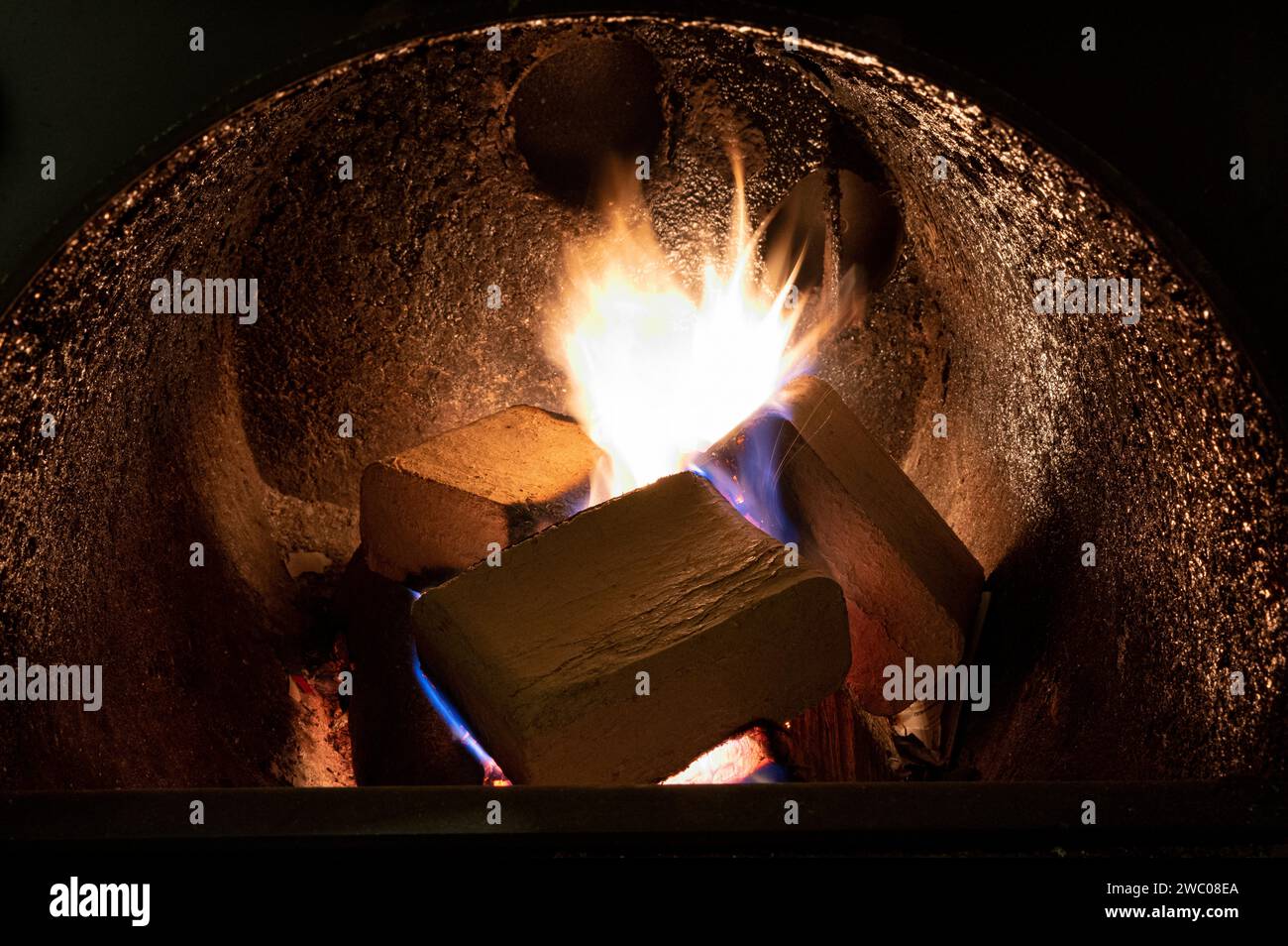 Wood briquettes (ruf type), made of beech and oak burning inside the ...