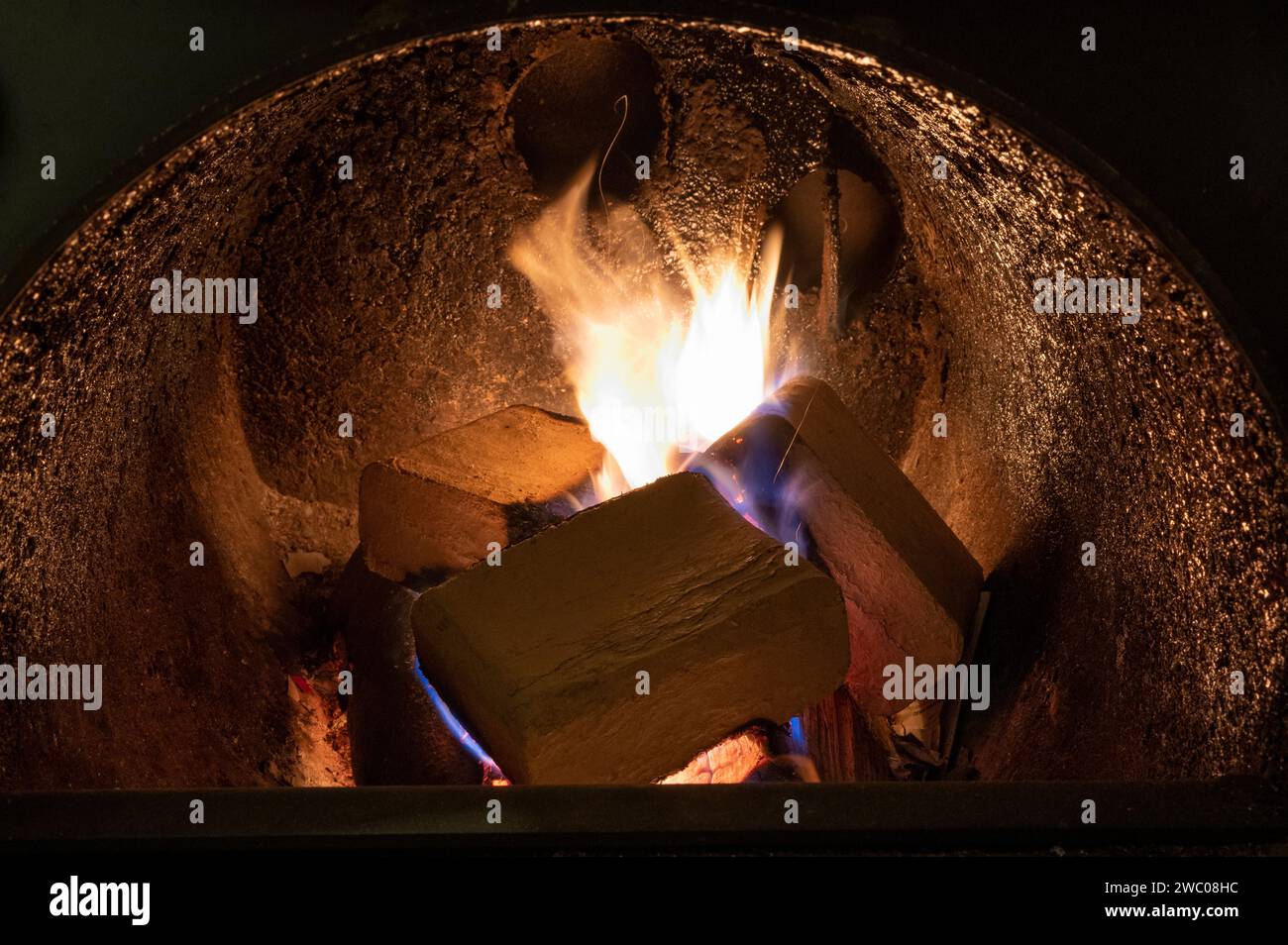 Wood briquettes (ruf type), made of beech and oak burning inside the ...