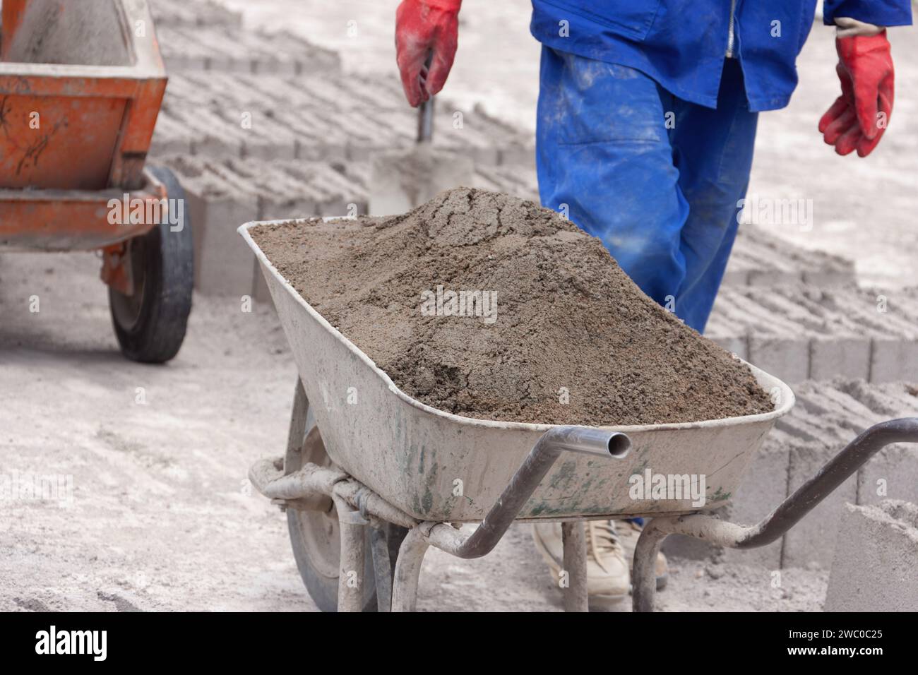 african man brick manufacturing wheelbarrow , made from cement concrete ...