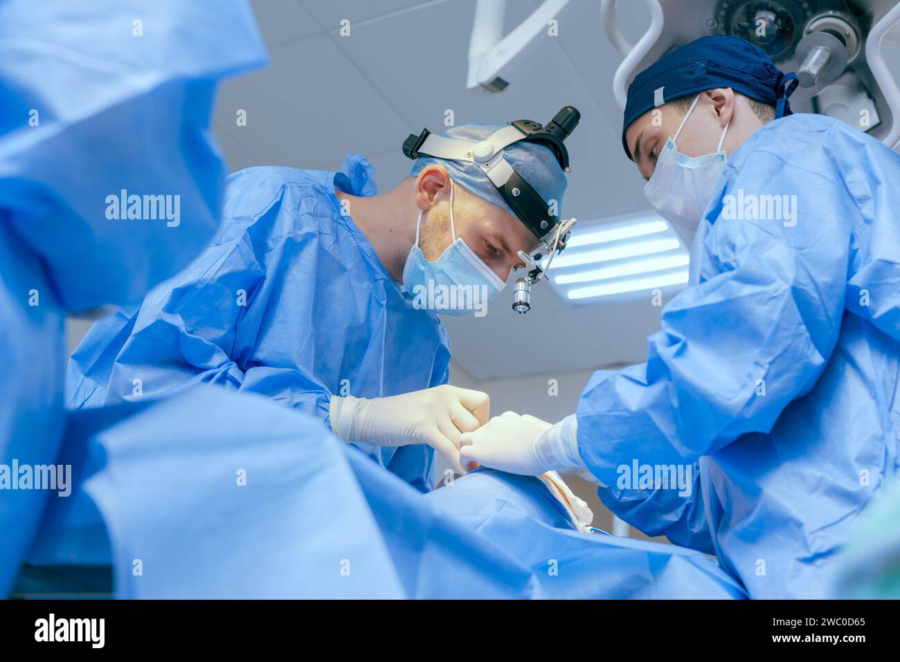 Professional male surgeons perform operation hi-res stock photography ...