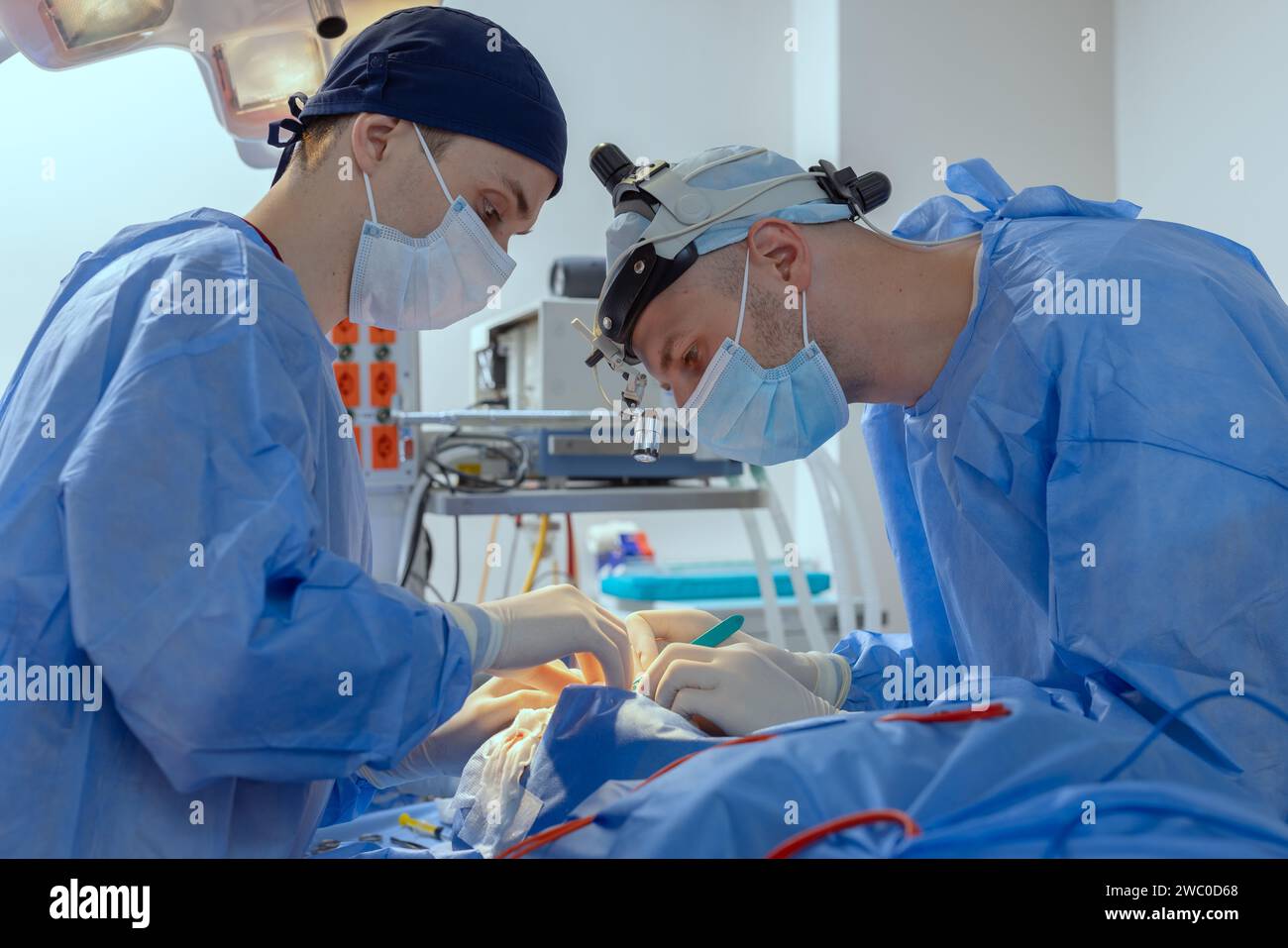 Professional male surgeons perform operation hi-res stock photography ...