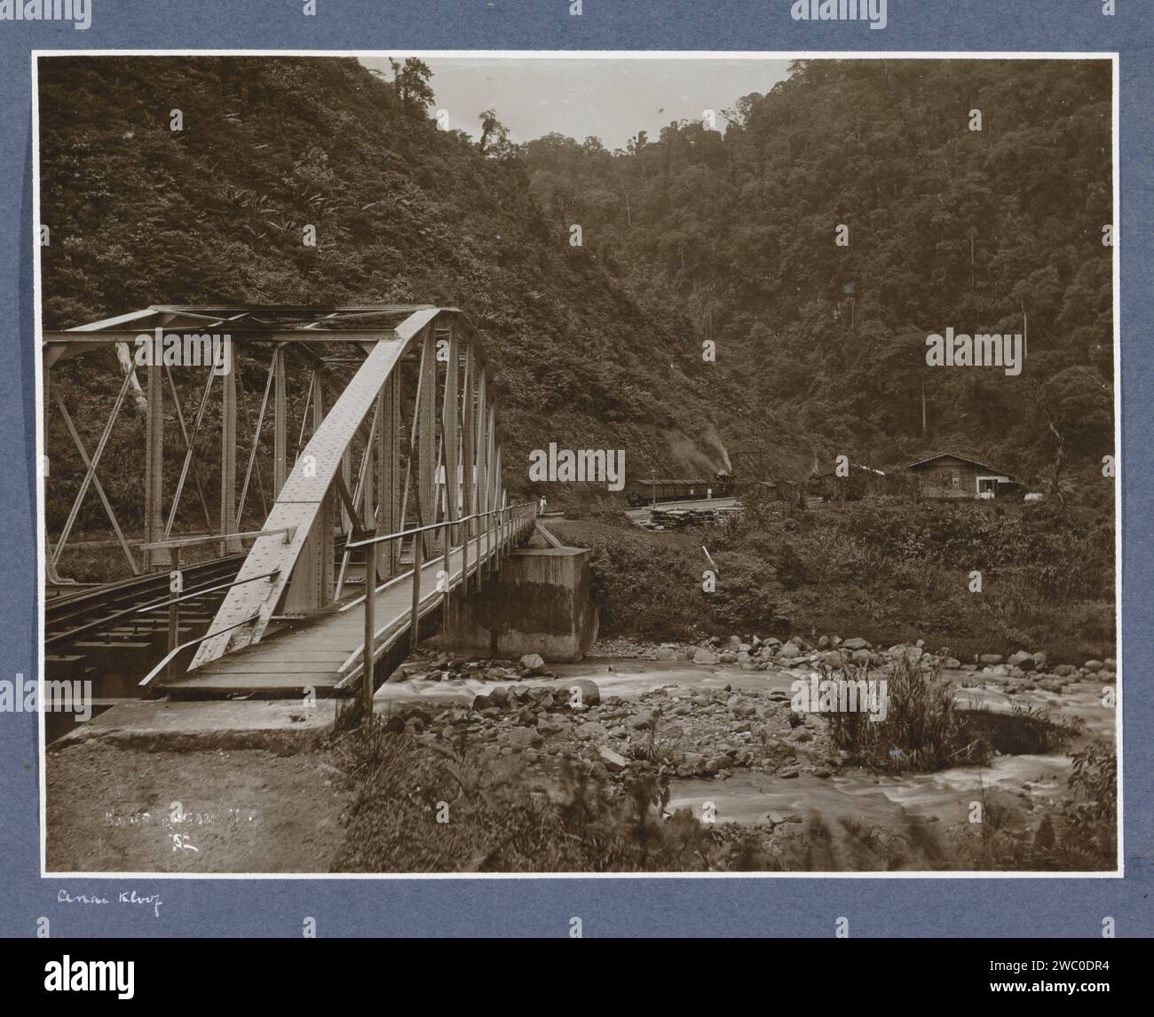 Rail and pedestrian bridge at Camp Tengah on Sumatra with a train in ...