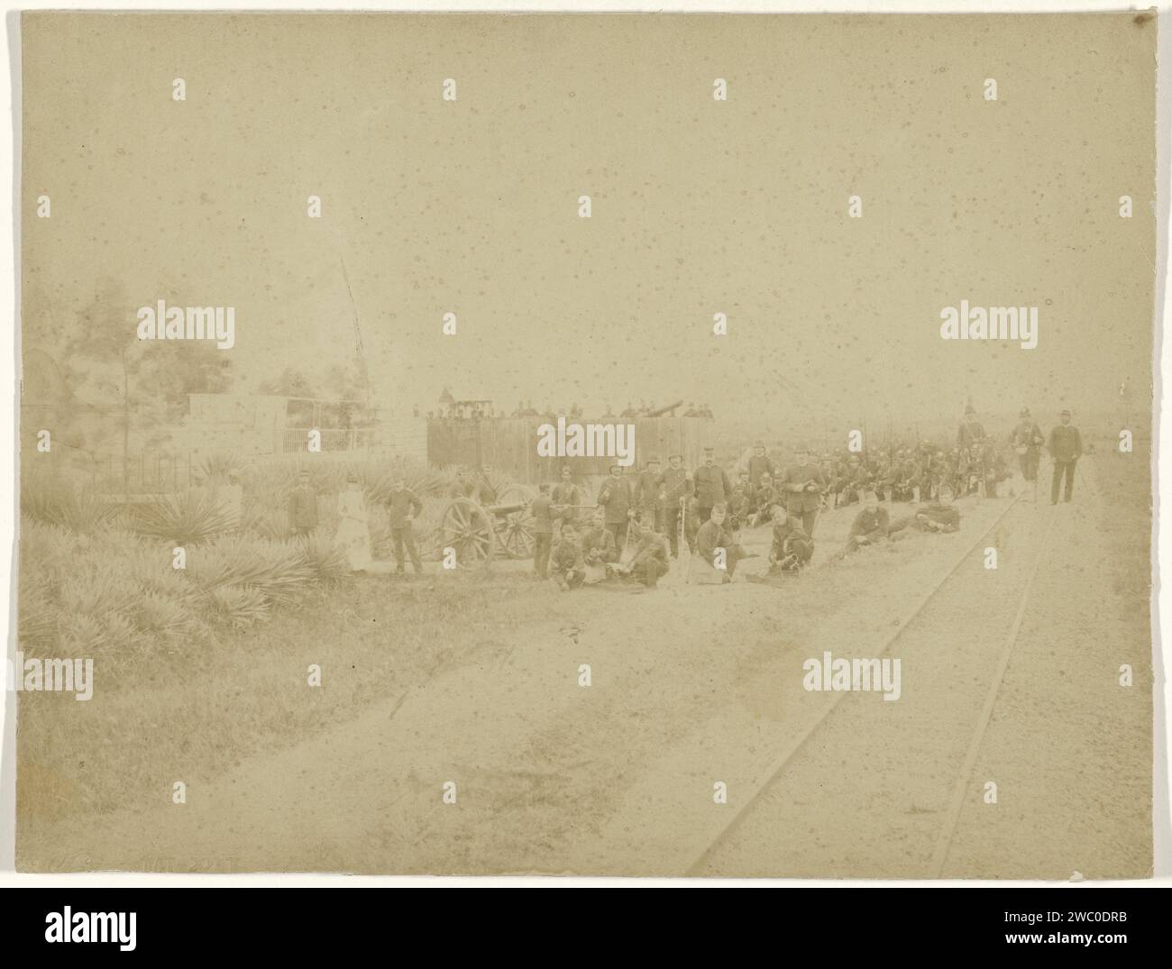 Group portrait of an unknown military company at a railway line and a ...