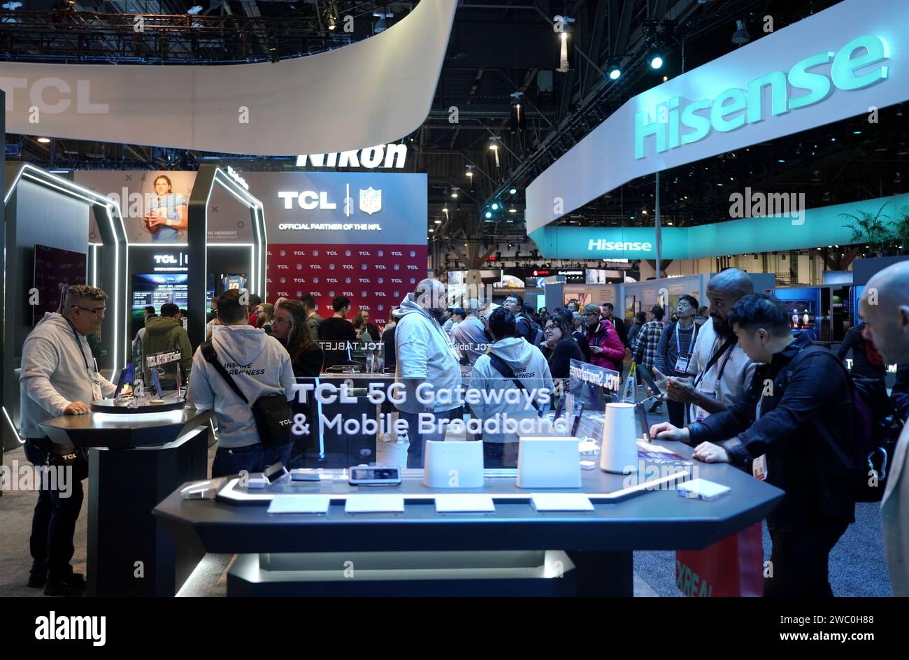 Las Vegas, USA. 11th Jan, 2024. People visit the exhibition areas of TCL (L) and Hisense (R ...