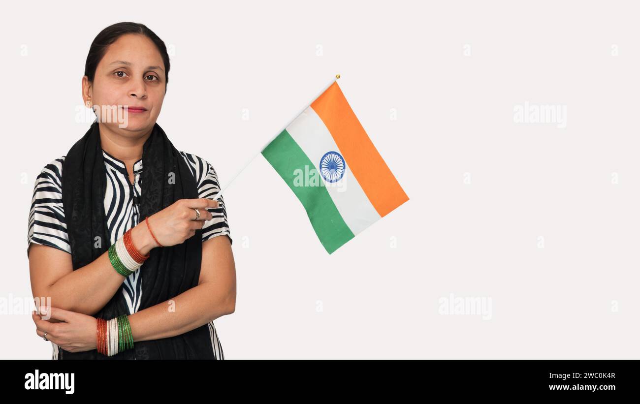 A young Indian lady carrying a national small flag with patriotic ...