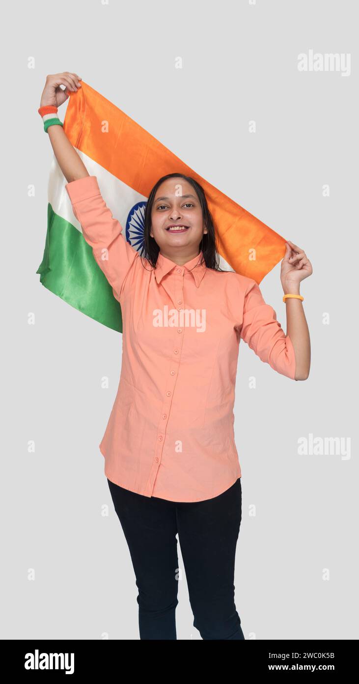 A young girl holding a national flag with a patriotic feeling, on ...