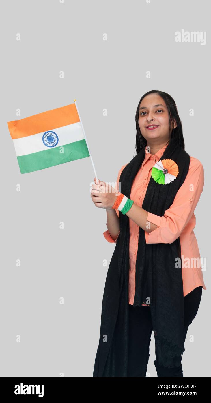 A young Indian lady carrying a national flag with a joyful patriotic ...