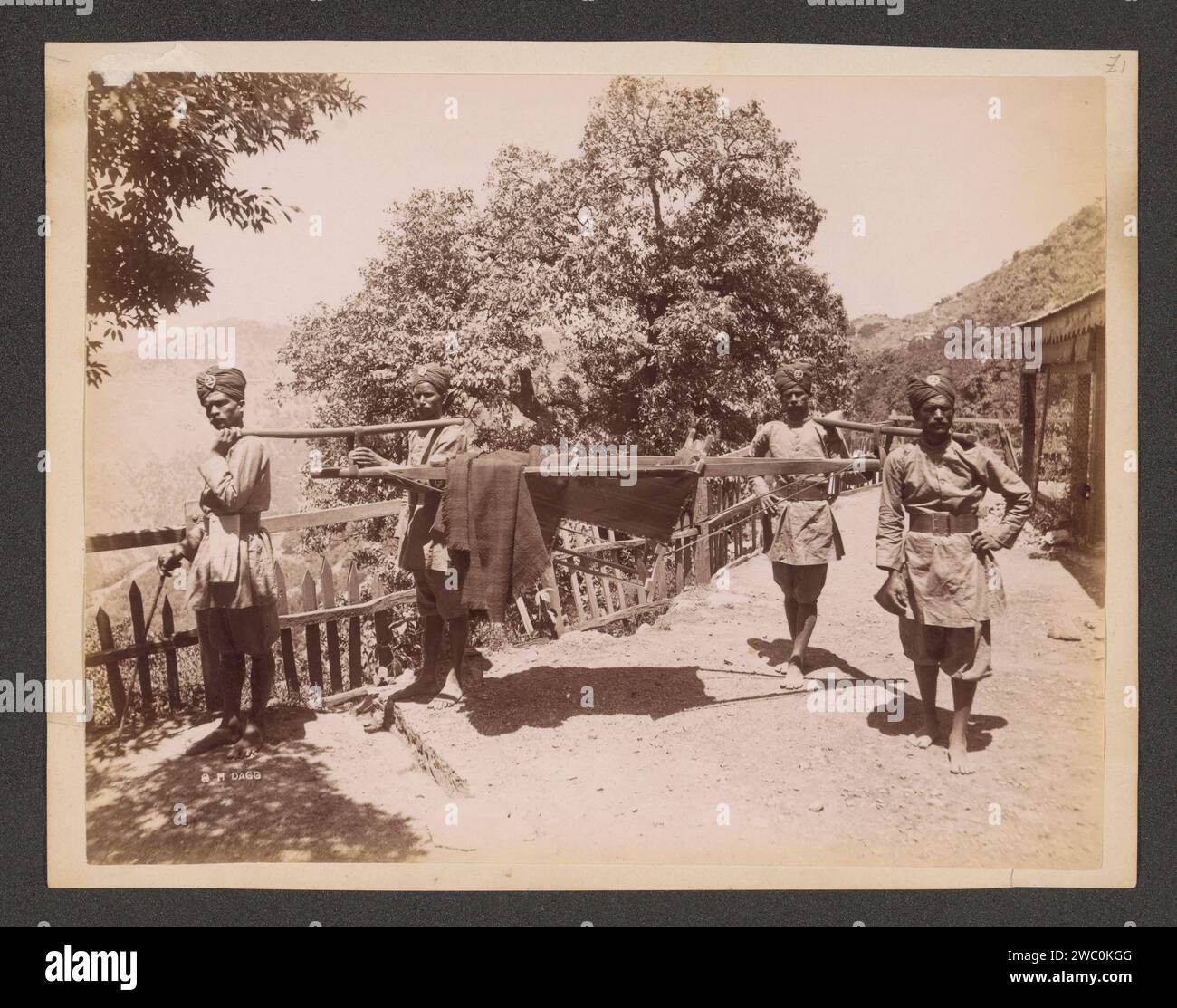 Four Indian men in unform life a palanquin, India, Sidney Herbert Dagg ...