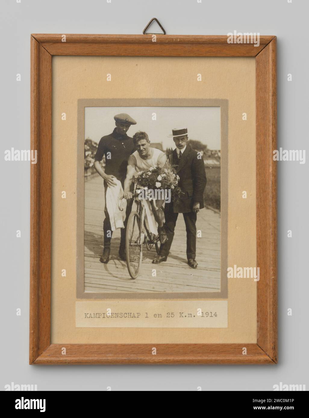 Portrait of John Stol on the bike with bouquet flowers and on either ...