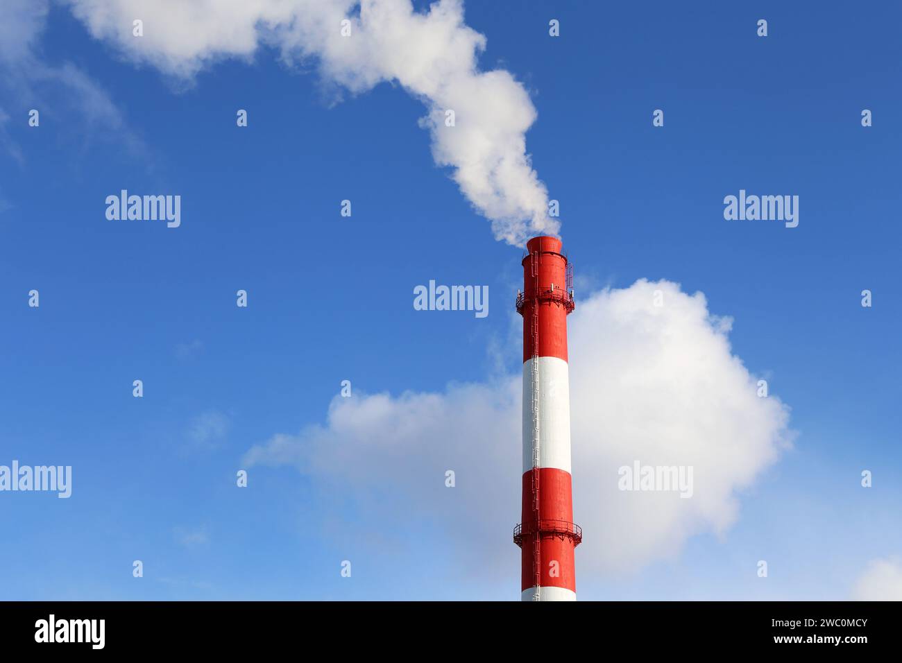 Factory chimney on blue sky and clouds background with white smoke ...