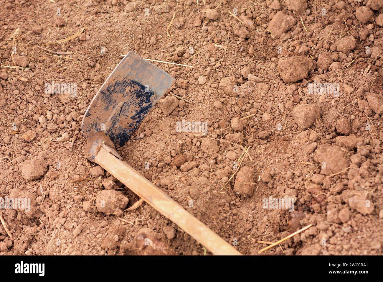 Soil with Hoe gardening tool Stock Photo - Alamy