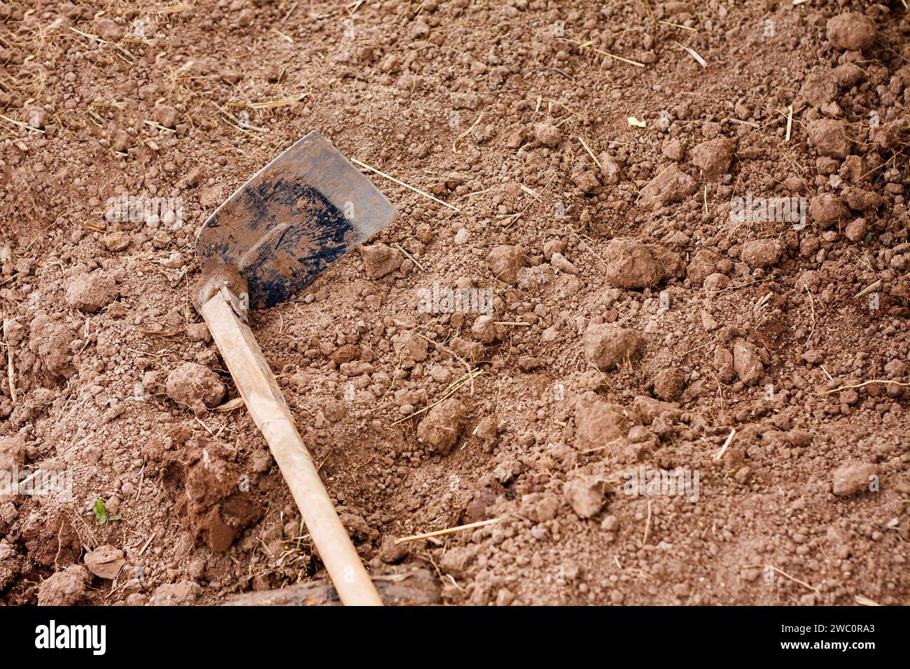Soil with Hoe gardening tool Stock Photo - Alamy