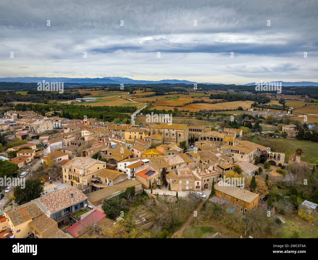 Aerial view of the village of Sant Jordi Desvalls on a cloudy winter ...