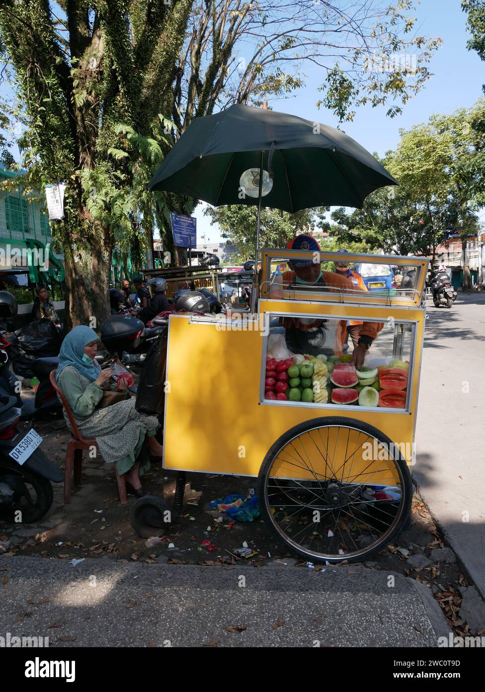 Indonesian Street Food Cart of Gerobak in Bandung, West Java, Indonesia selling fresh tropical ...