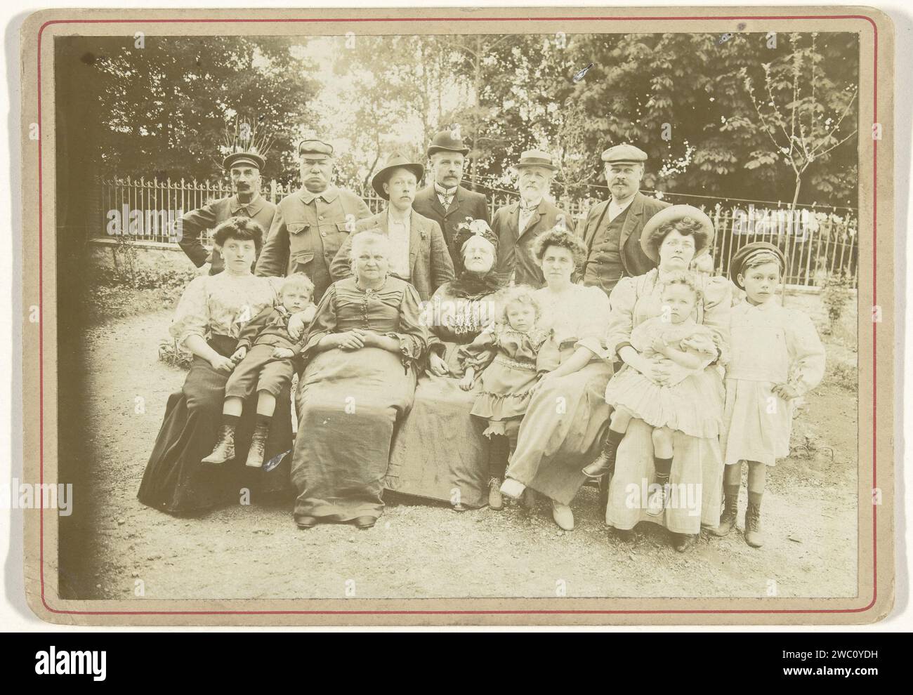Family portrait of unknown members of three generations in a garden ...