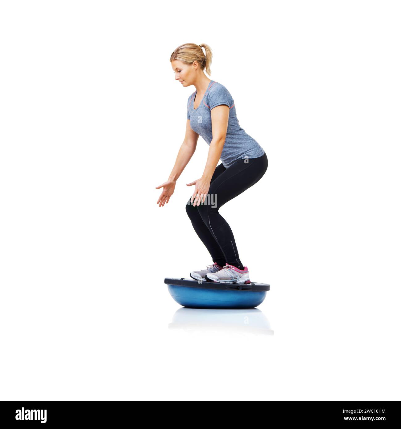 Woman, studio and squat with exercise, ball or balance for legs, muscle ...